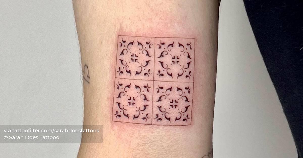 Tiles tattoo located on the bicep, illustrative style.