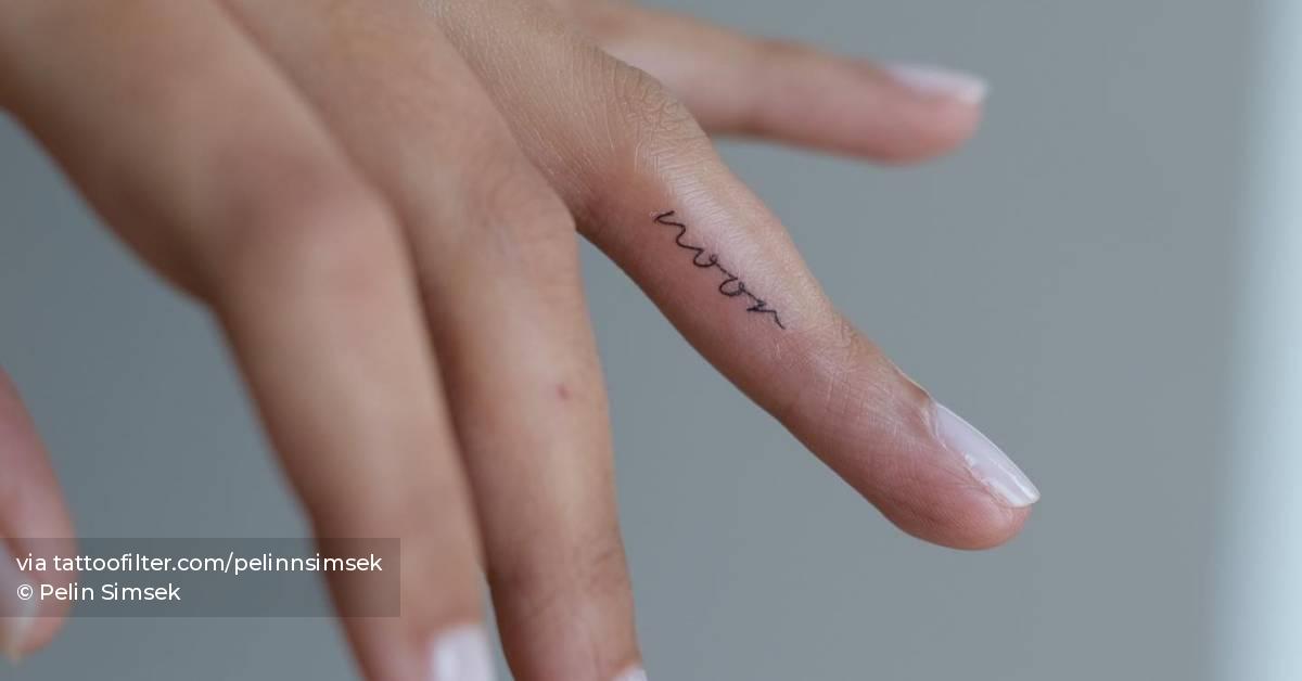 Tiny lettering tattoo handwritten on the finger.