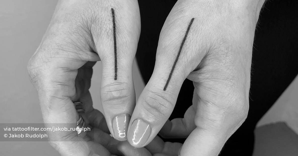 Individual matching lines tattoo located on the thumb.