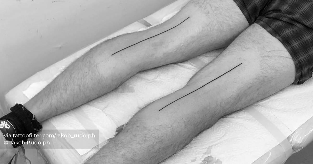Individual matching lines tattooed on the legs.