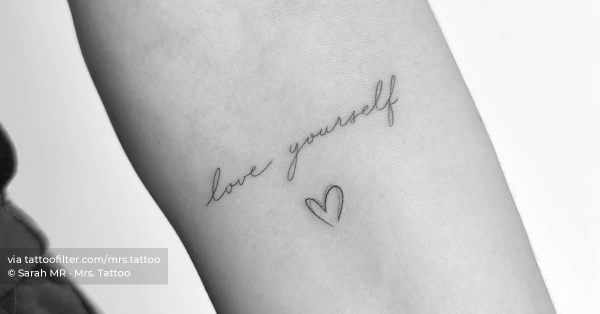 Tattoo that says "love yourself" located on the inner