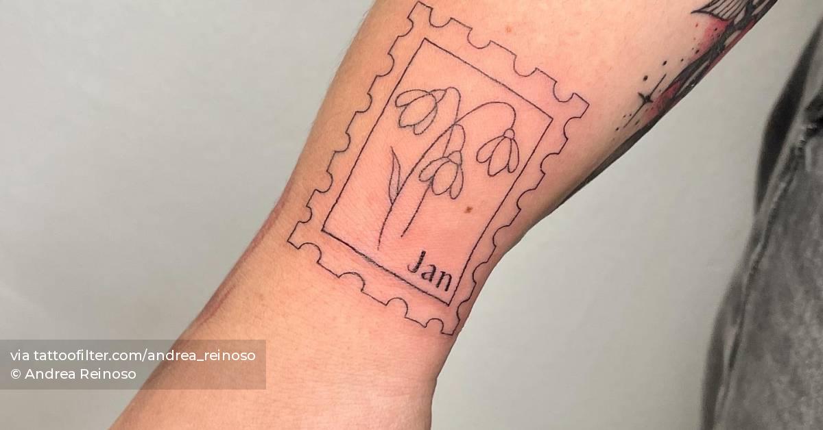 Fine line style snowdrop stamp tattoo located on the