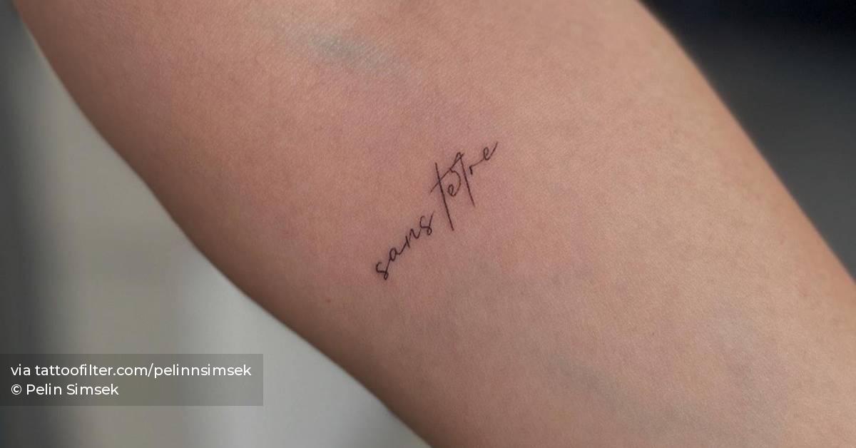 Handwritten lettering tattoo located on the inner