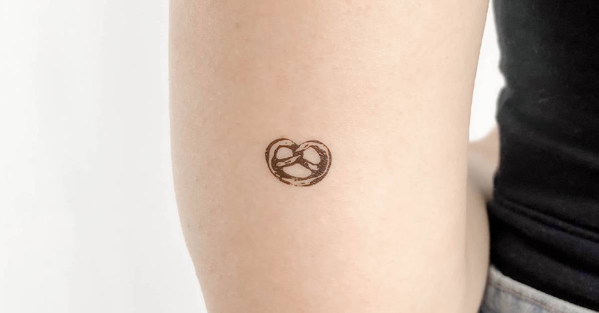Small pretzel temporary tattoo located on the tricep.