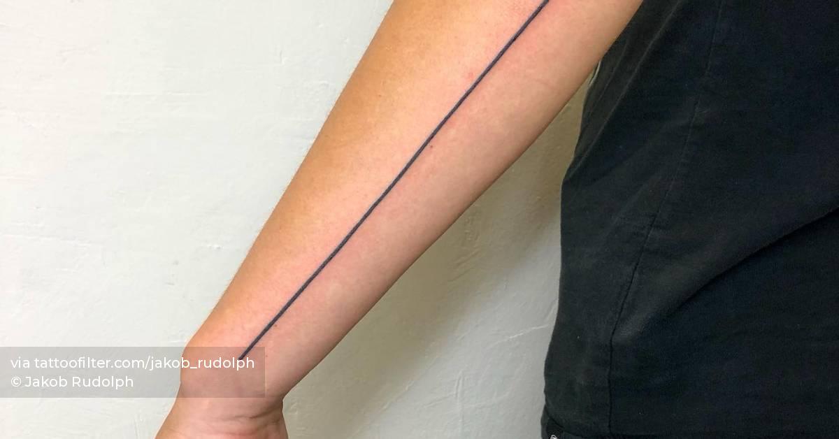 Minimalistic style line tattooed on the arm.