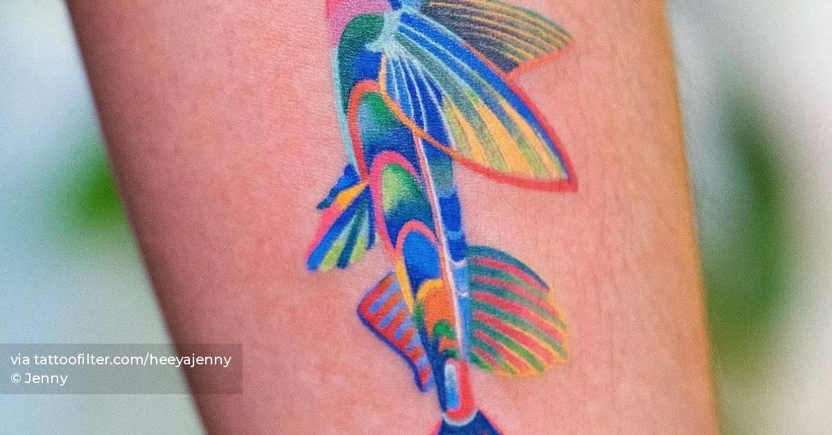 Watercolor style flying fish tattoo placed on the inner