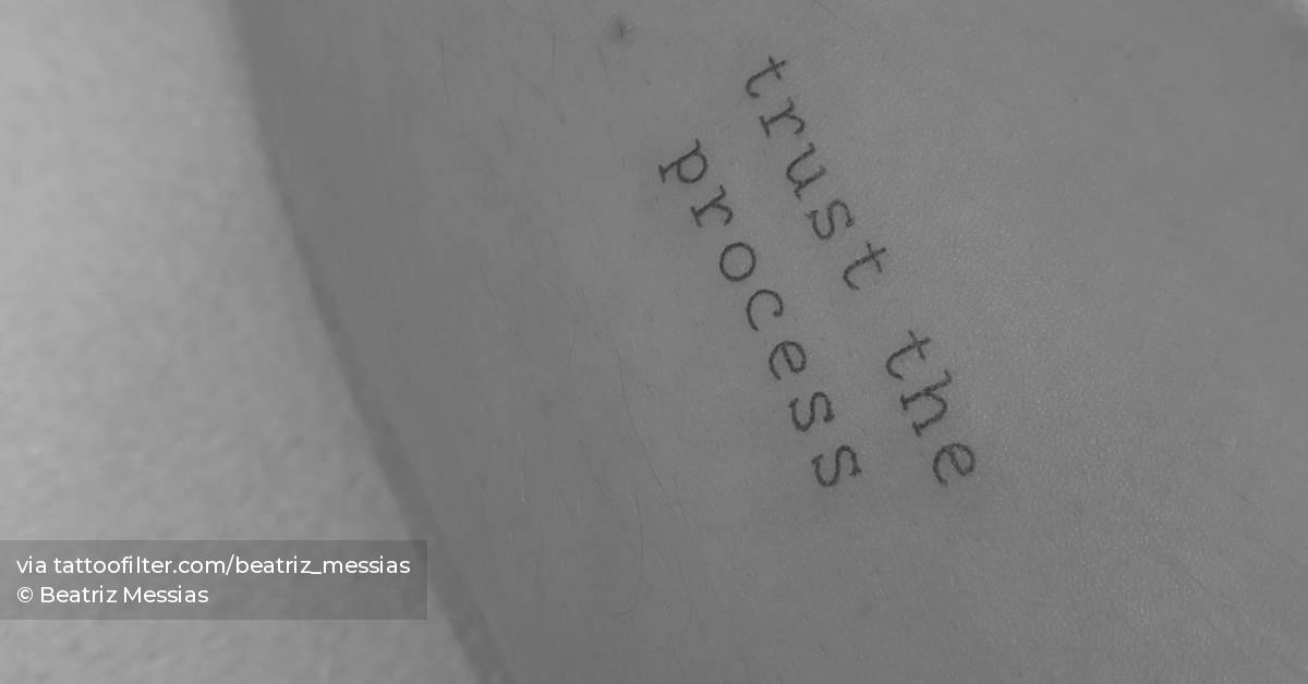 "Trust the process" lettering tattoo placed on the