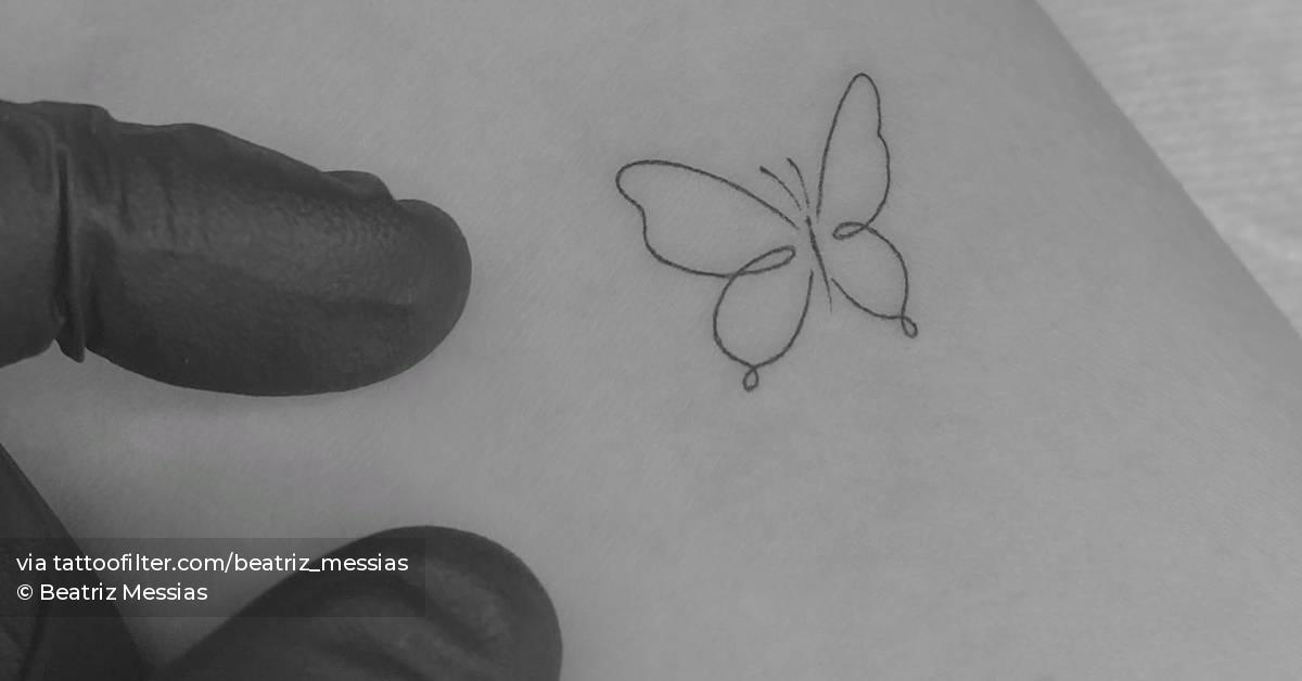 Fine line style butterfly tattoo located on the inner