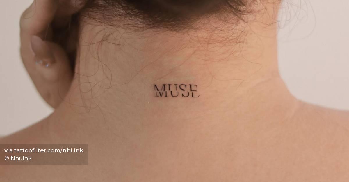 Tattoo of the word "muse" located on the back of the