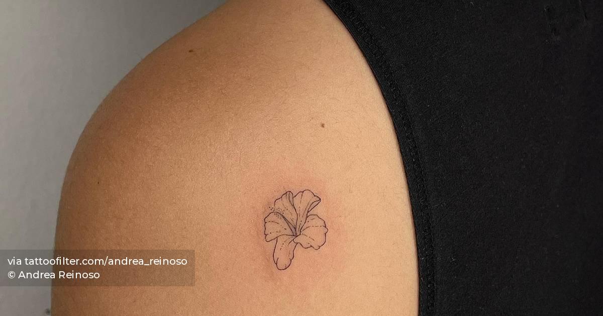 Fine line style hibiscus flower tattoo located on the