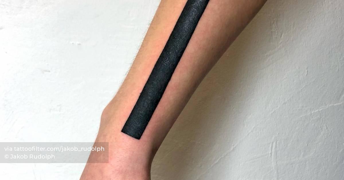 Blackwork style line tattoo located on the forearm.