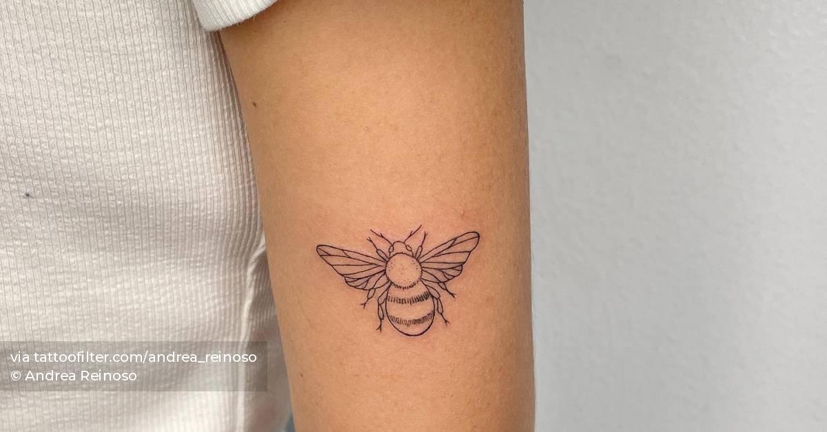 Fine line style bee tattoo placed on the tricep.