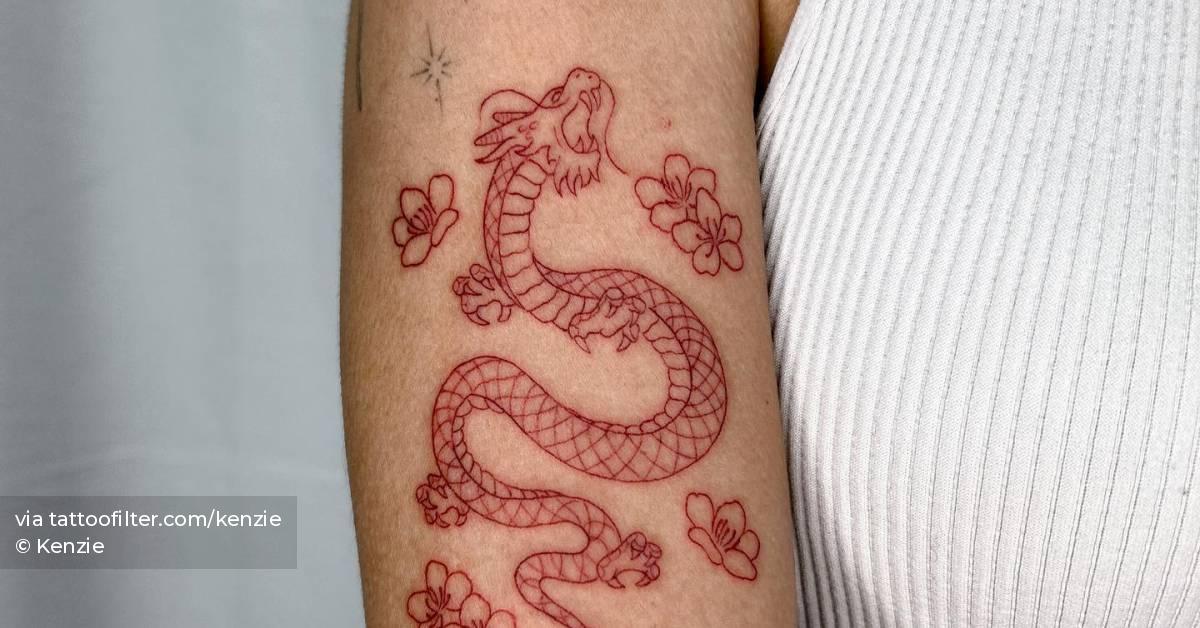 Red dragon tattoo located on the upper arm.