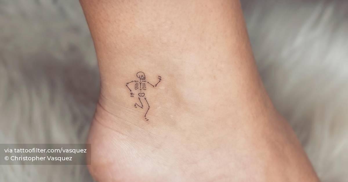 Fine line style dancing skeleton tattoo placed on the