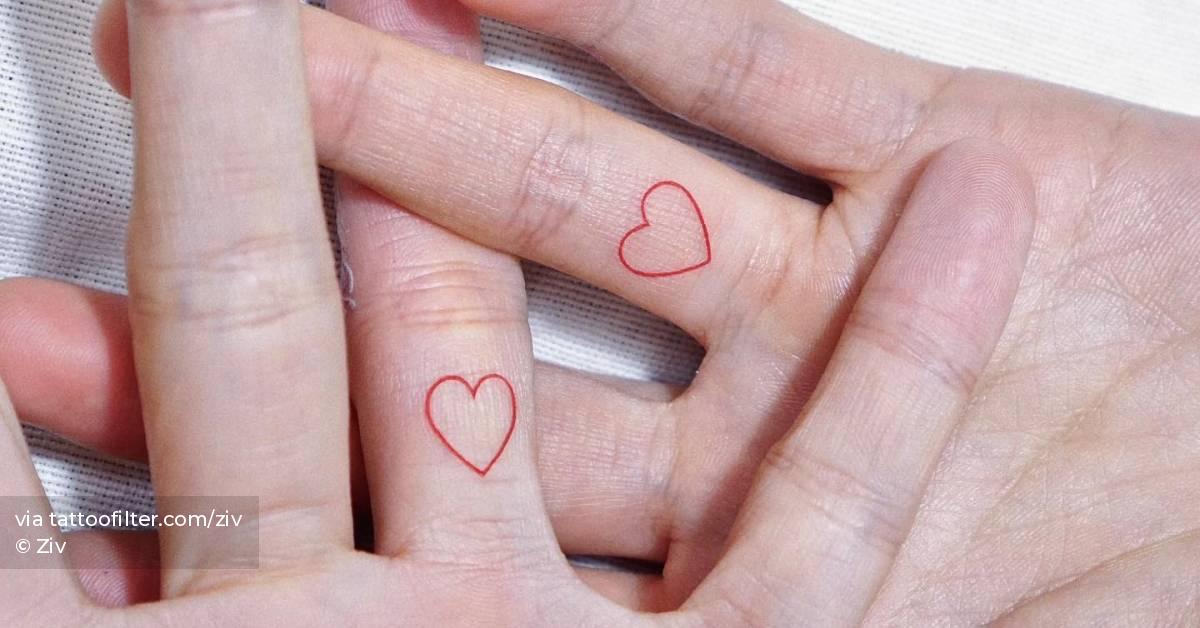 Matching minimalistic red heart tattoo for couple.