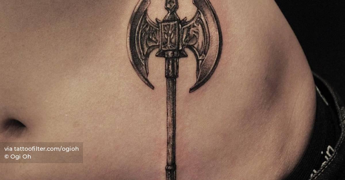 Black and grey axe tattoo located on the waist.