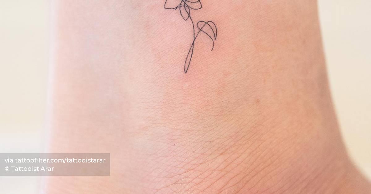 One line flower tattoo located on the ankle.