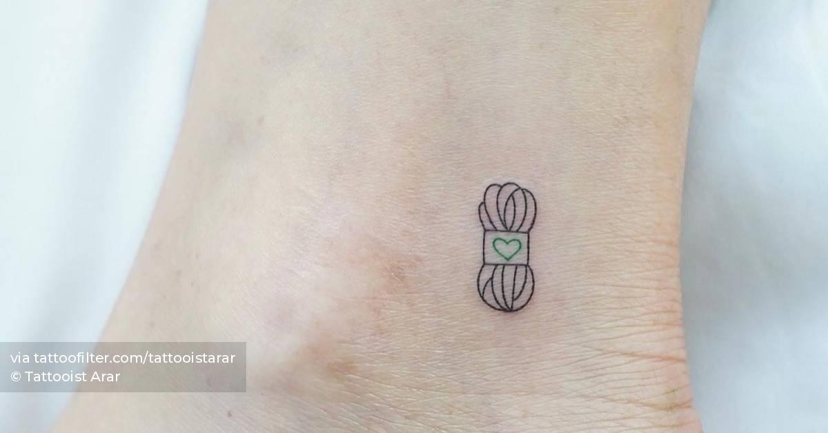 Minimalistic style wool yarn tattoo placed on the