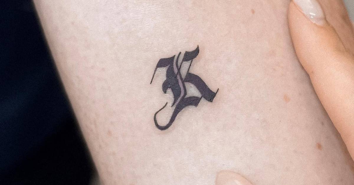 Letter "K" tattoo in gothic font located on the inner