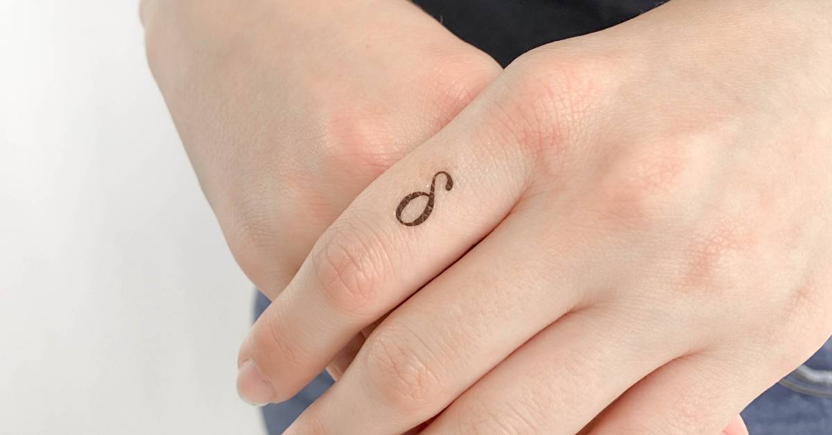 Delta δ temporary tattoo placed on the finger.