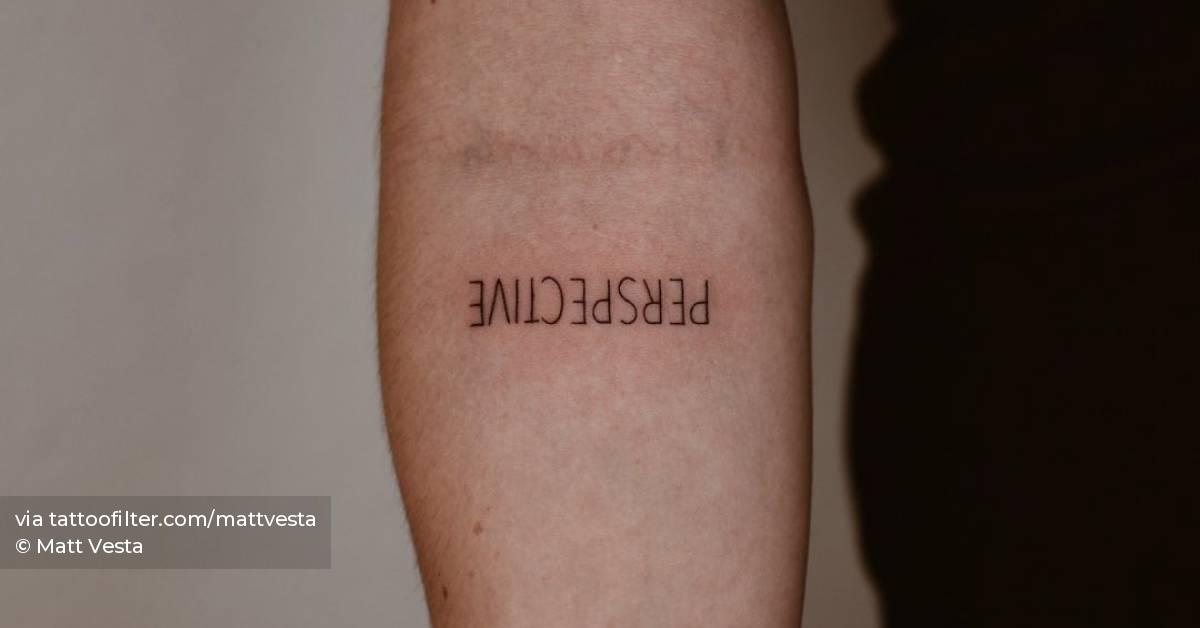 Tattoo of the word "perspective" handwritten on the