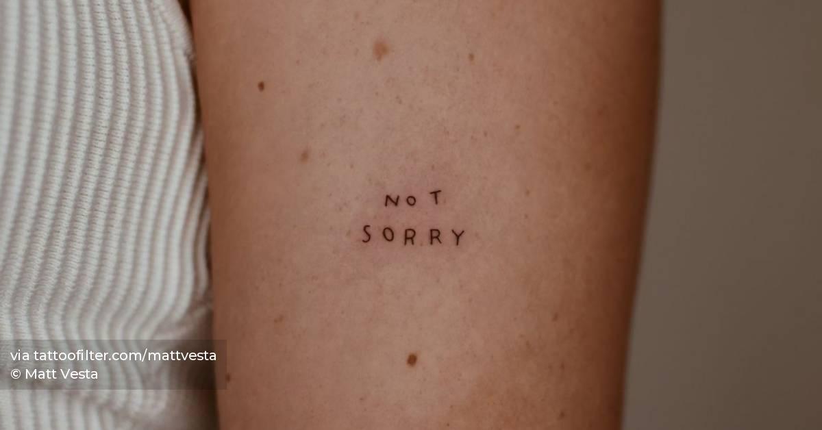 "Not sorry" lettering tattoo handwritten on the upper