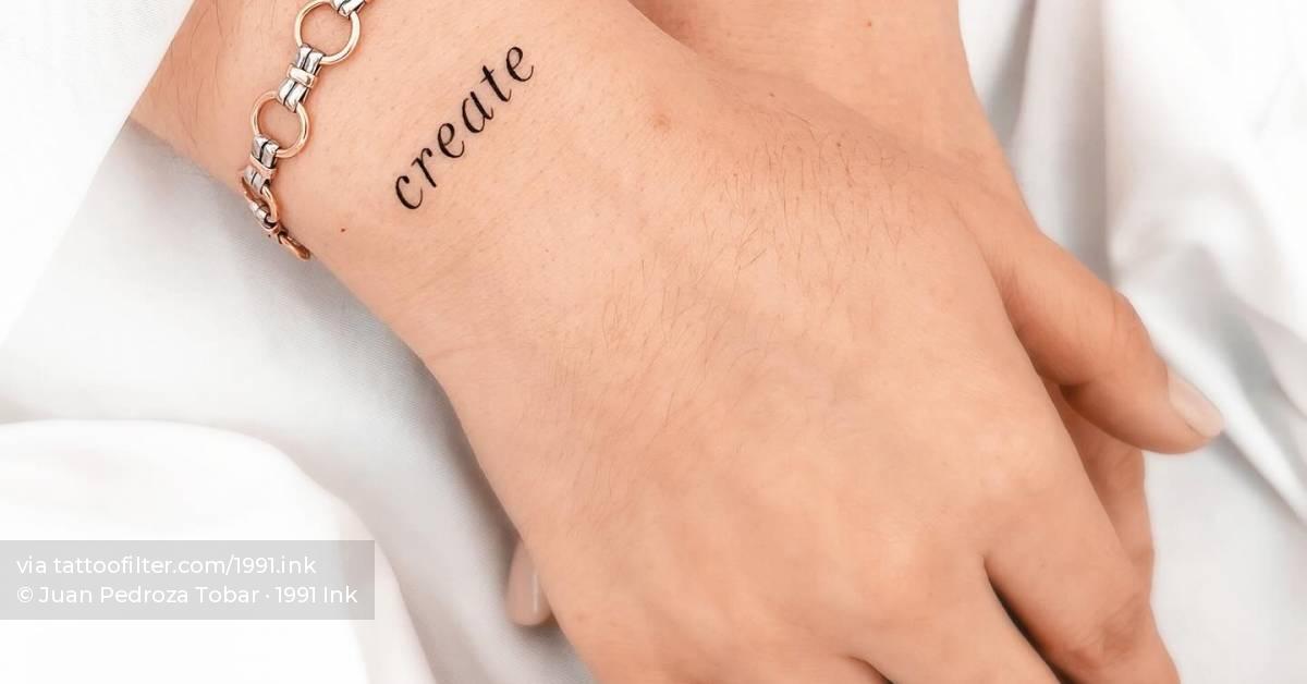Words "create" and "imagine" tattooed on the wrist.