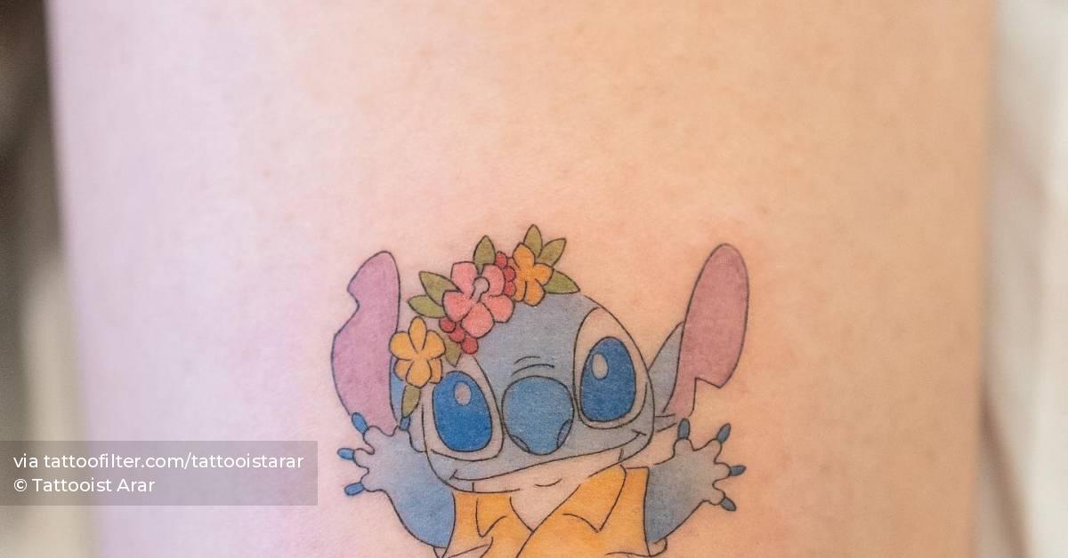 Cartoon style Stitch tattoo located on the upper arm.