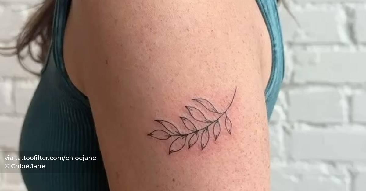 Fine line style leaves tattoo located on the upper arm.