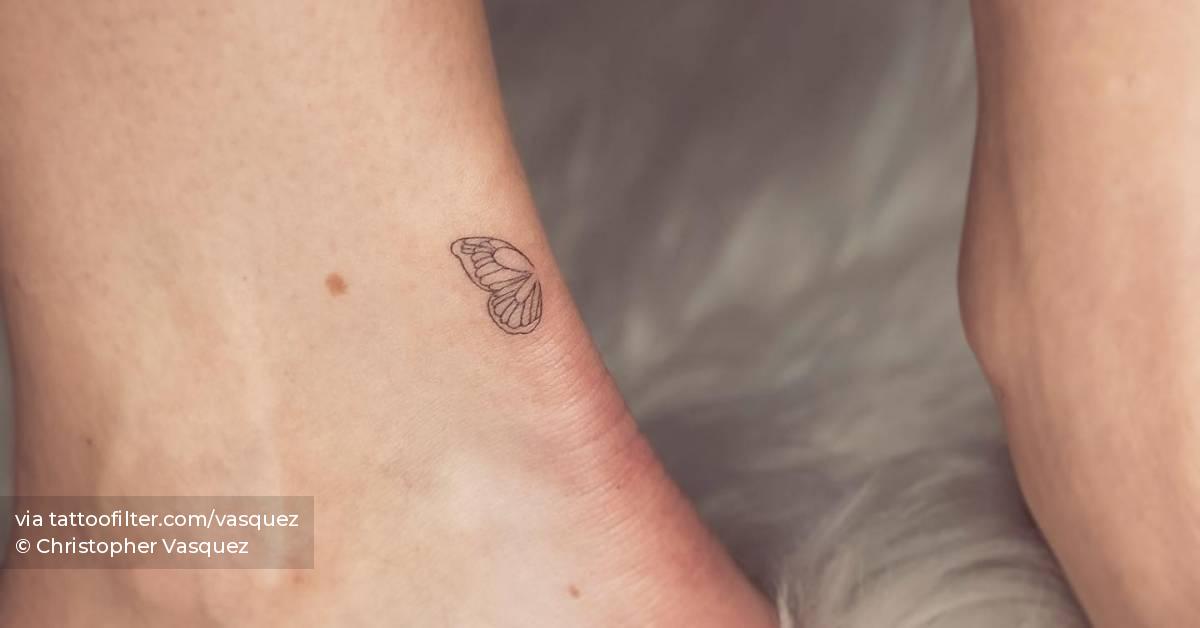 Cute fine line style butterfly wing tattoo located on