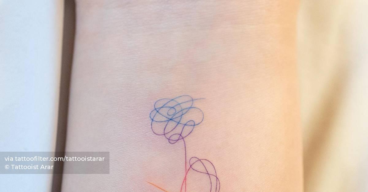 Spectrum one line flower tattoo located on the wrist.