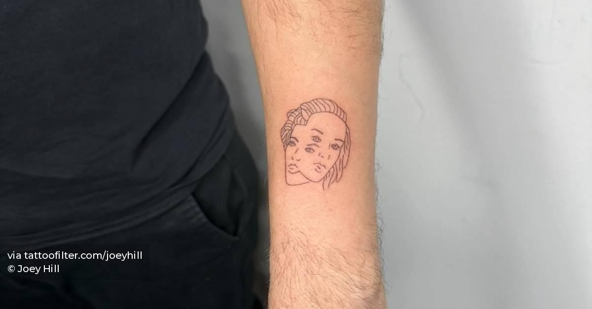 Fine line style head tattoo located on the wrist.
