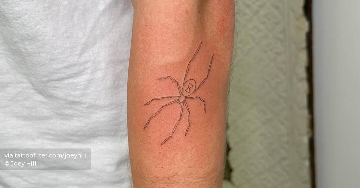 Spider tattoo located on the forearm, done in fine line
