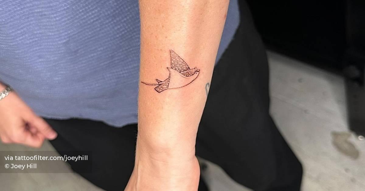 Spotted eagle ray tattoo located on the wrist,