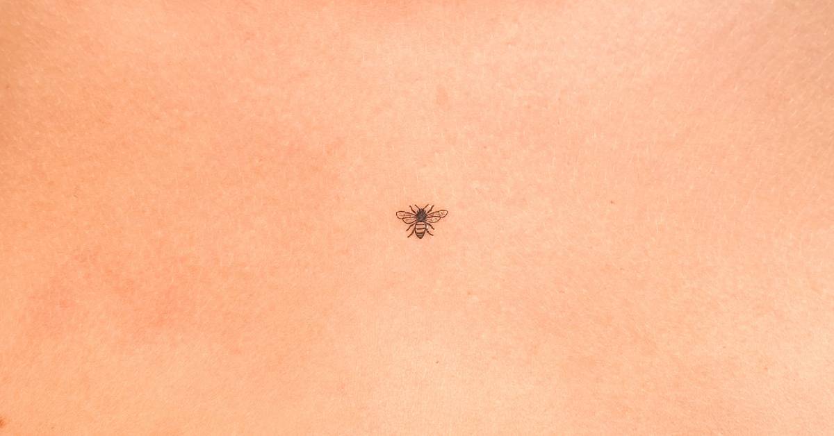 Micro bee temporary tattoo placed on the chest.
