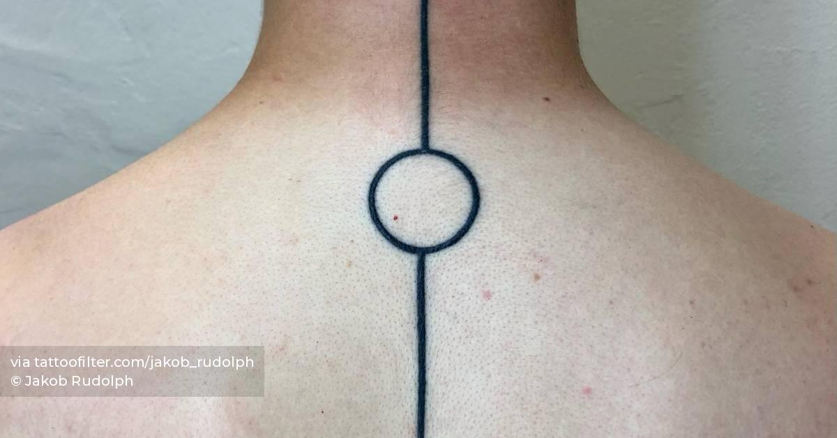 Line and circle tattoo located on the back and neck.