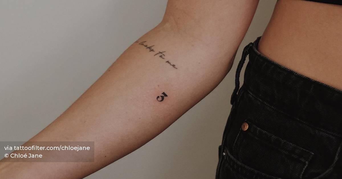 Tiny tattoo of the number "3" located on the inner
