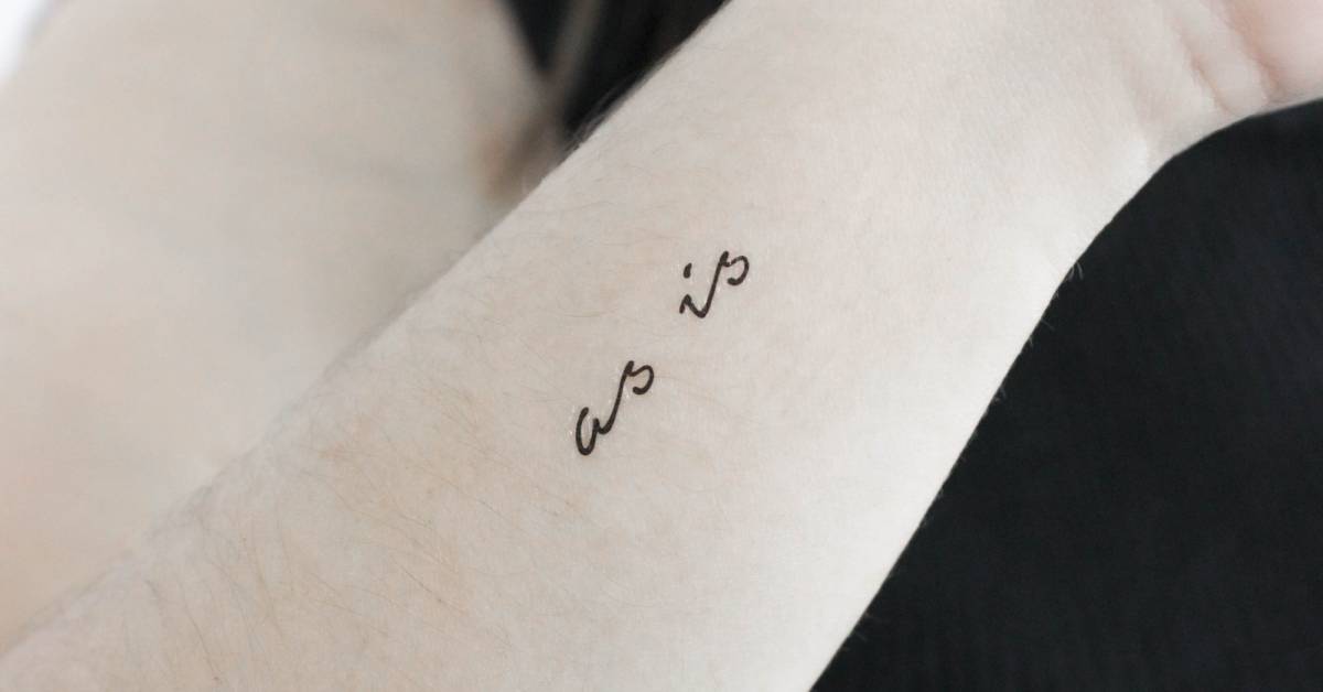 "As is" temporary lettering tattoo located on the