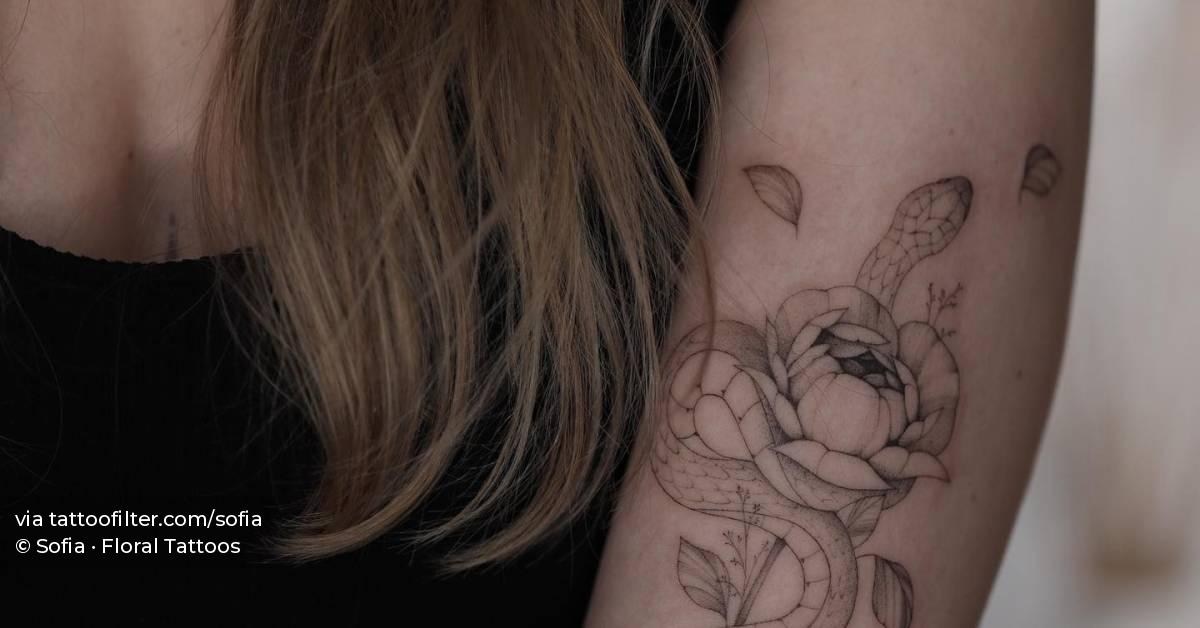 Freehand peony and snake tattoo located on the upper