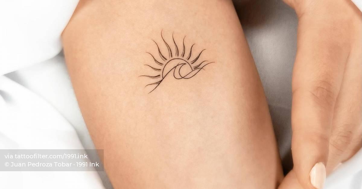Fine line style sun and wave tattoo located on the