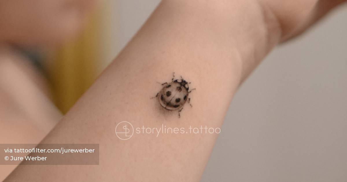 Super cute and tiny realistic ladybug tattoo.
