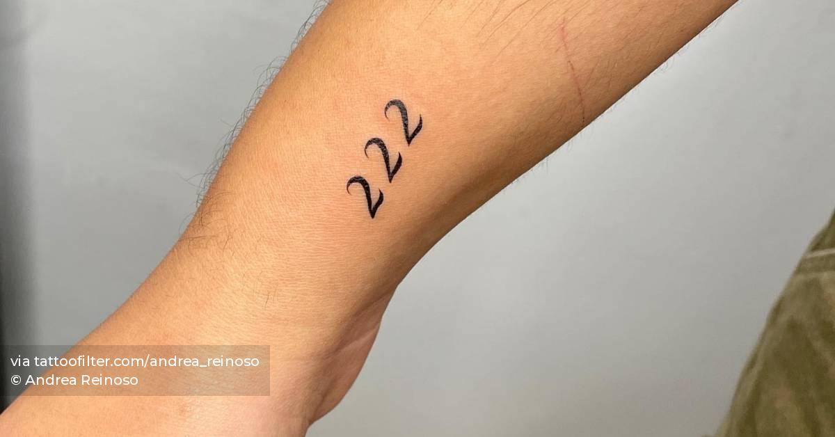 Angel number "222" tattoo located on the wrist.
