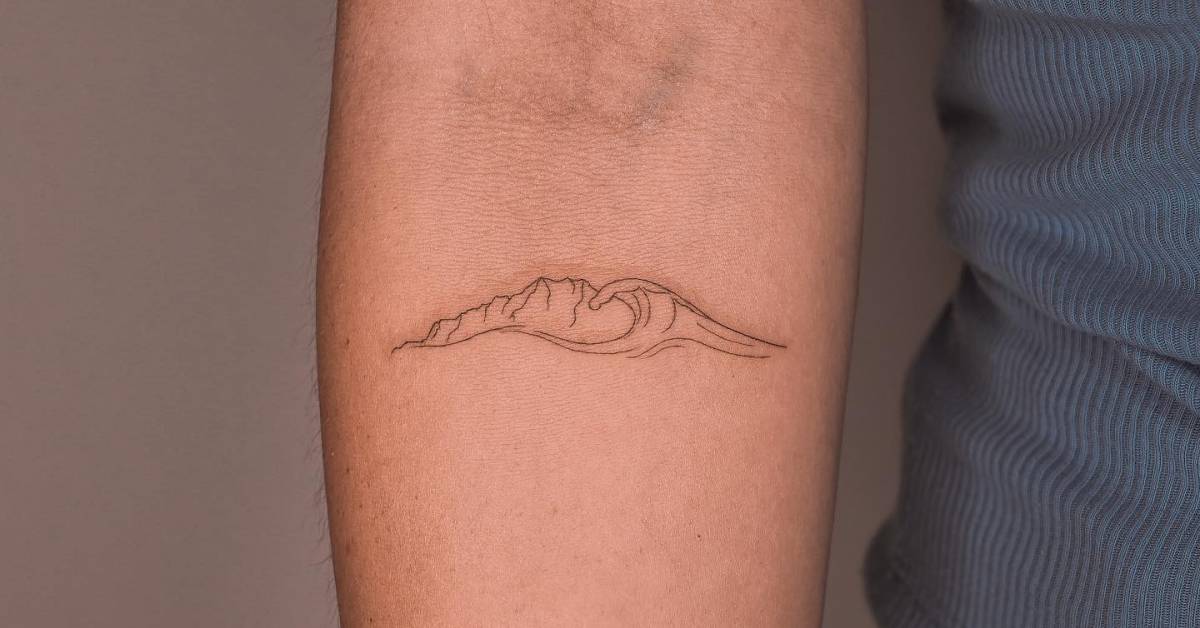 Fine line style wave tattoo located on the inner