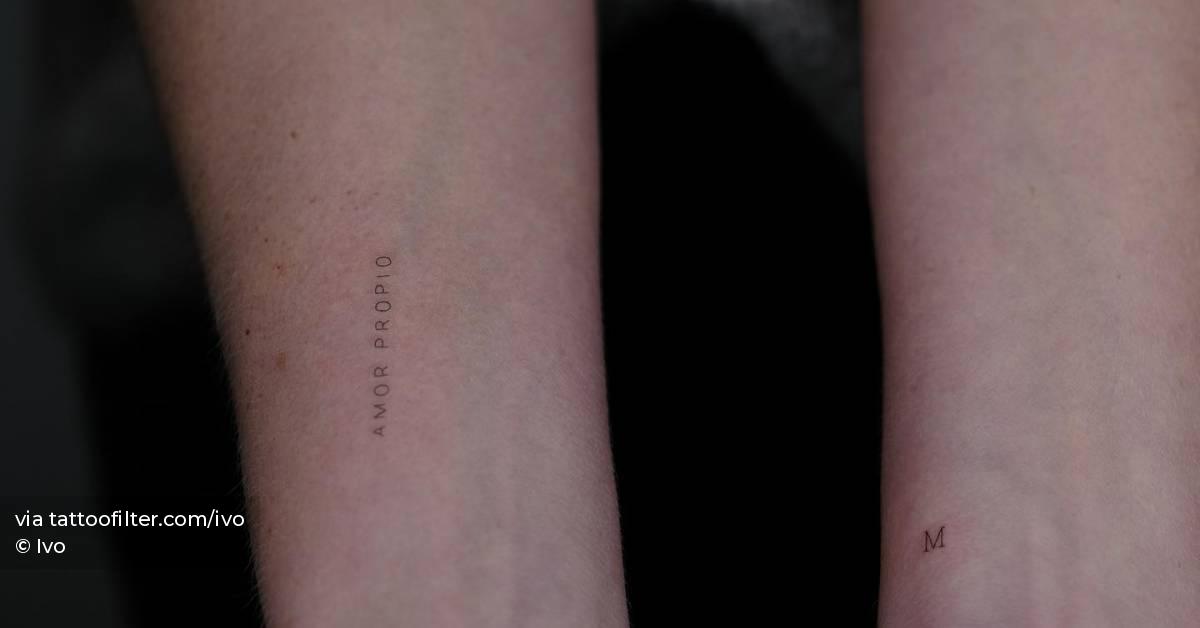 "Amor propio" and little "M" lettering tattoos.