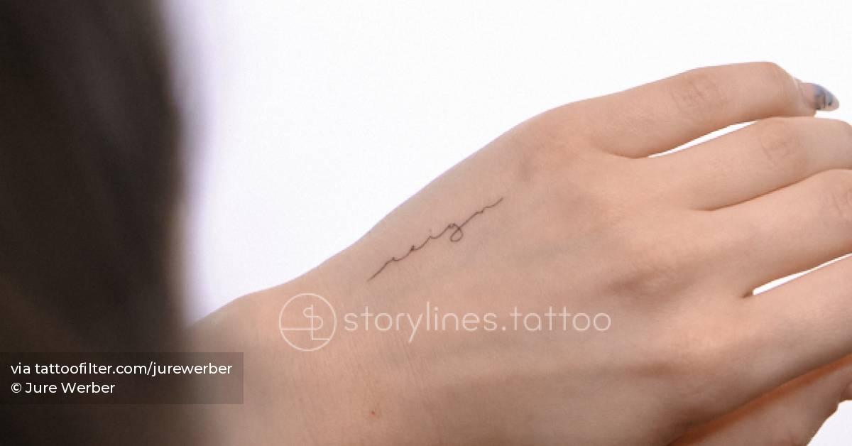 'reign' lettering tattoo.