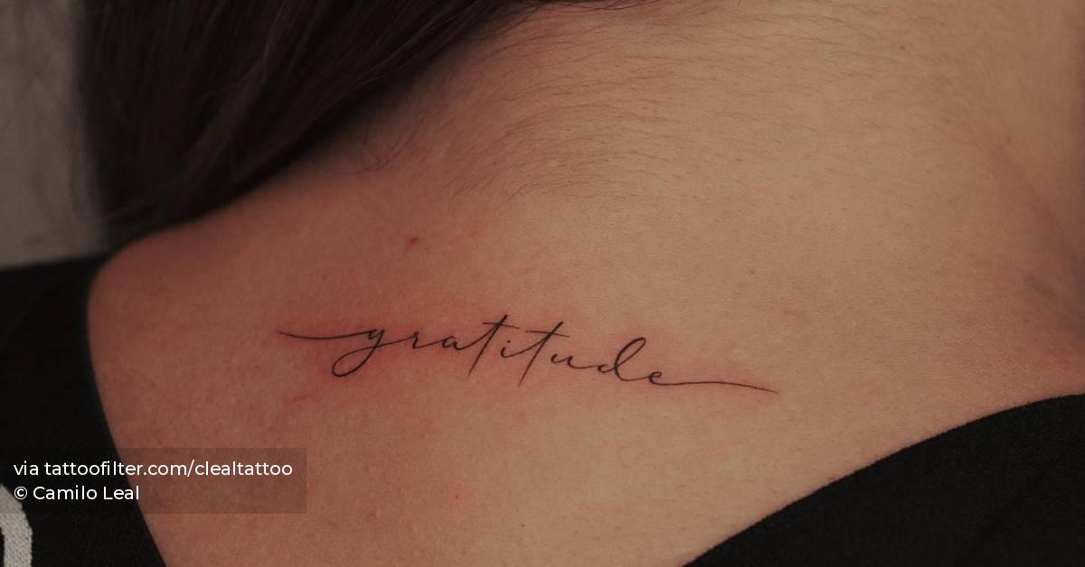 Tattoo of the word "gratitude" placed on the upper