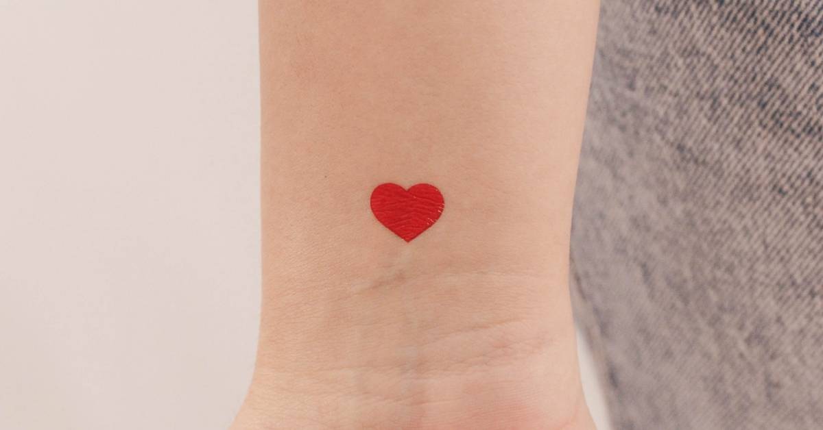 Small heart in red temporary tattoo done on the wrist.