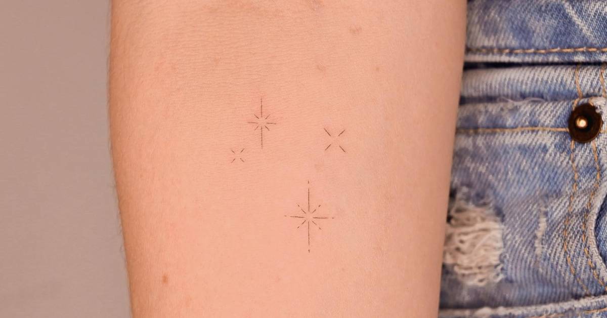 Fine line style minimalistic stars tattooed on the