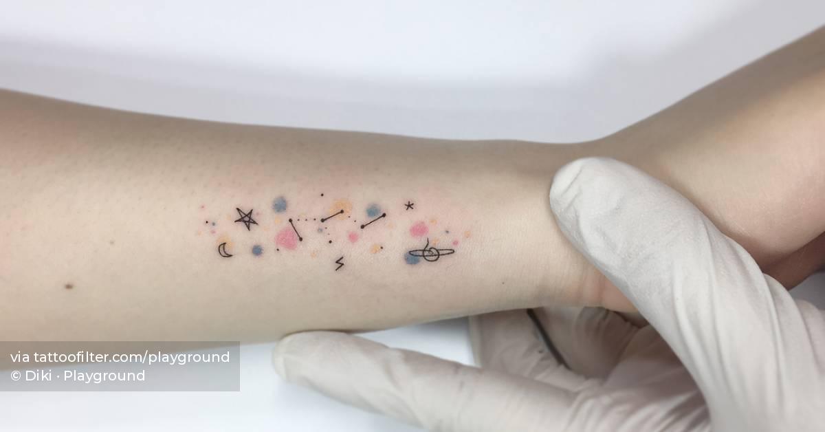 Colorful minimalistic universe tattoo located on the