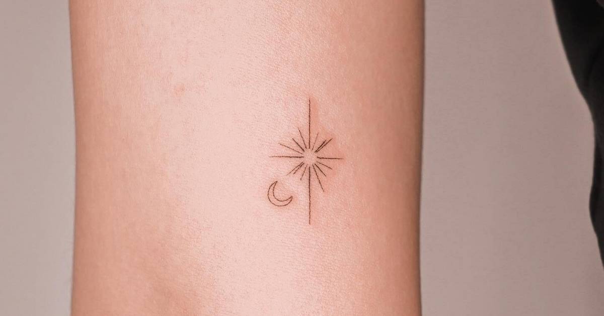 Fine line style star and moon tattoo located on the